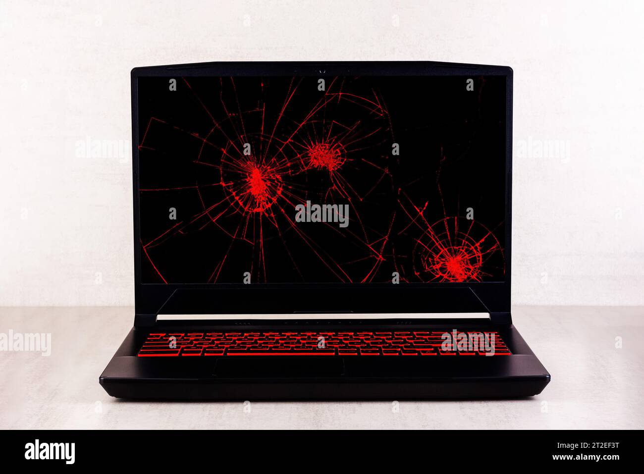 a gaming laptop with traces of bumps and cracks on a broken screen on a ...