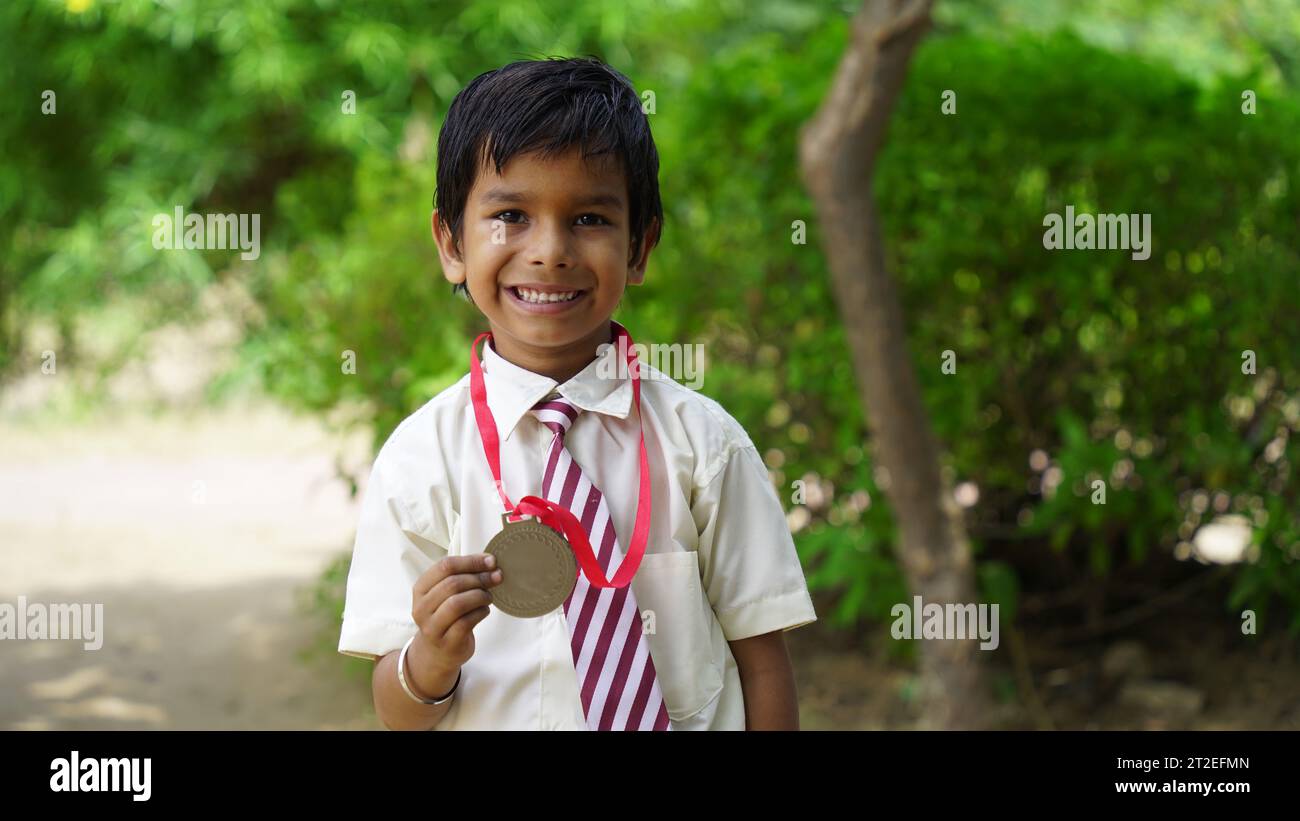 Portrait of a Happy School boy wearing school uniform celebrating ...