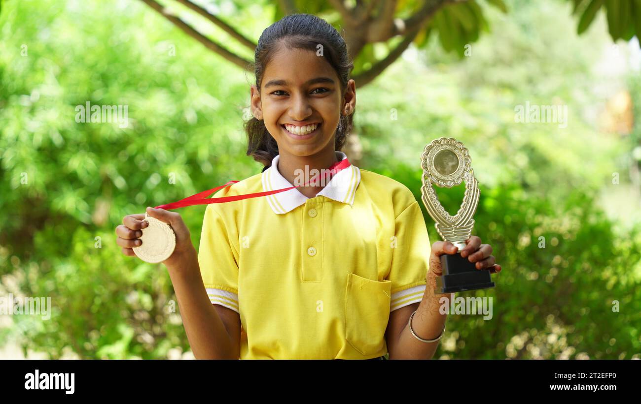 Portrait of a Happy School girl wearing school uniform celebrating ...
