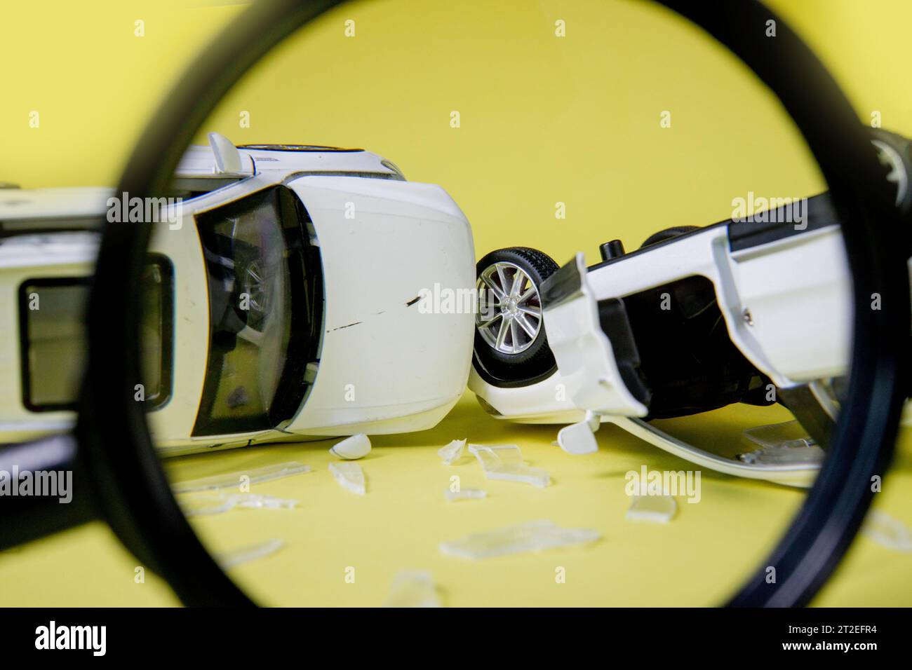 Two mini toy car crash on yellow background, incident, car traffic ...