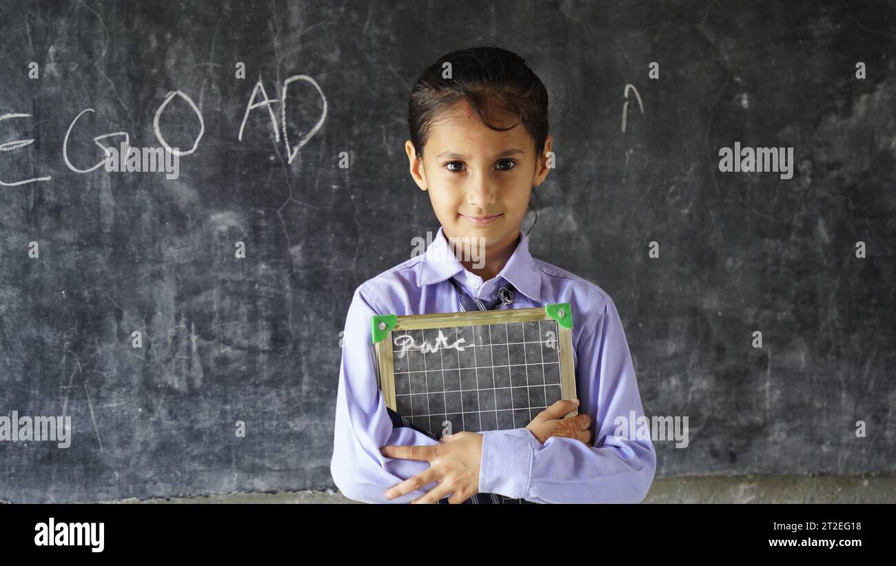 Portrait of Happy cheerful Indian school child or kids in uniform ...
