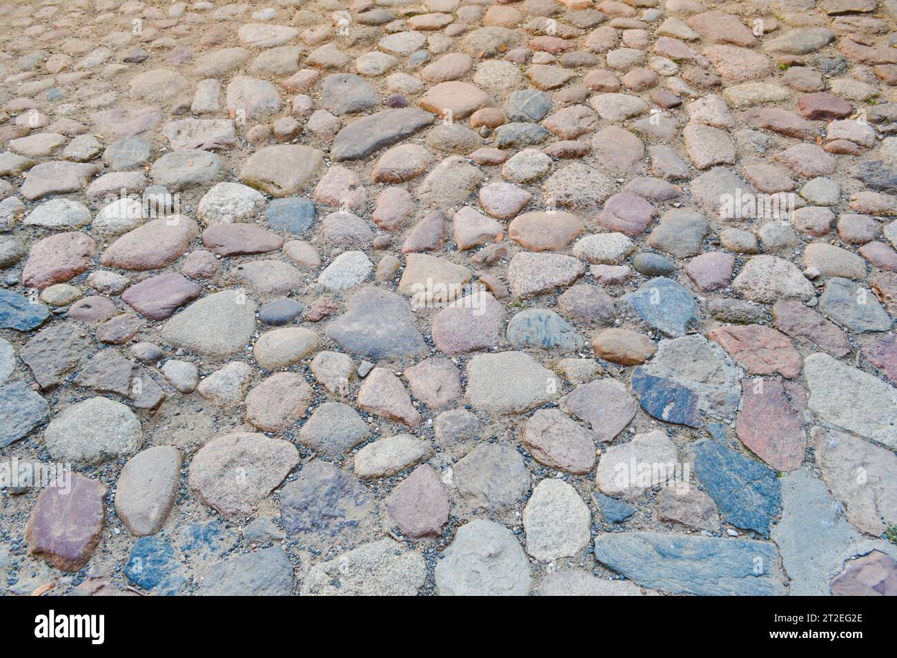 The texture of the stone road, pavement, walls of large gray old ...