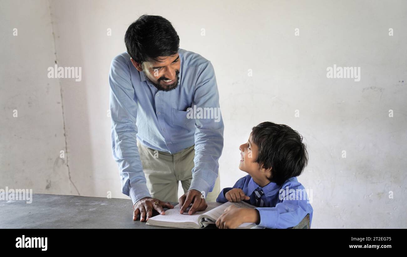 Indian teacher teaching to rural school student in classroom, Typical ...