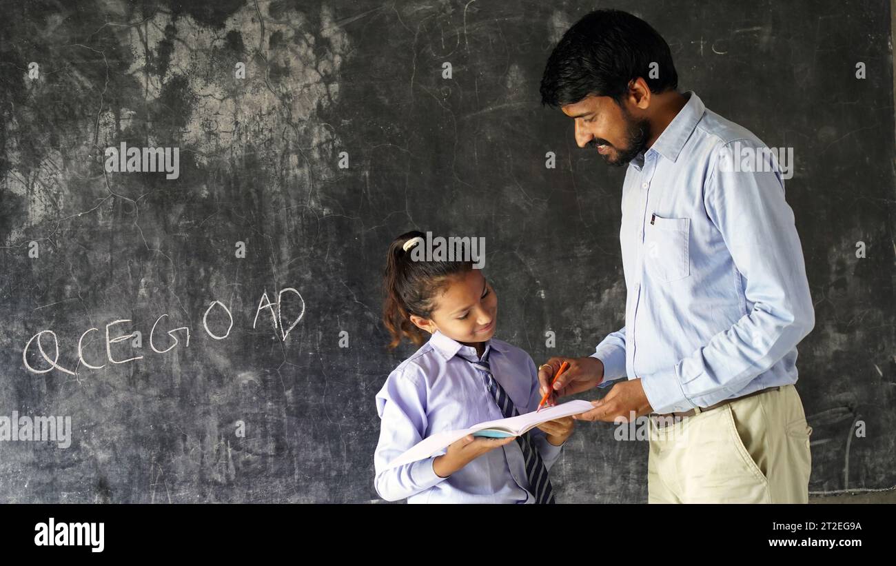 Indian teacher teaching to rural school student in classroom, Typical ...