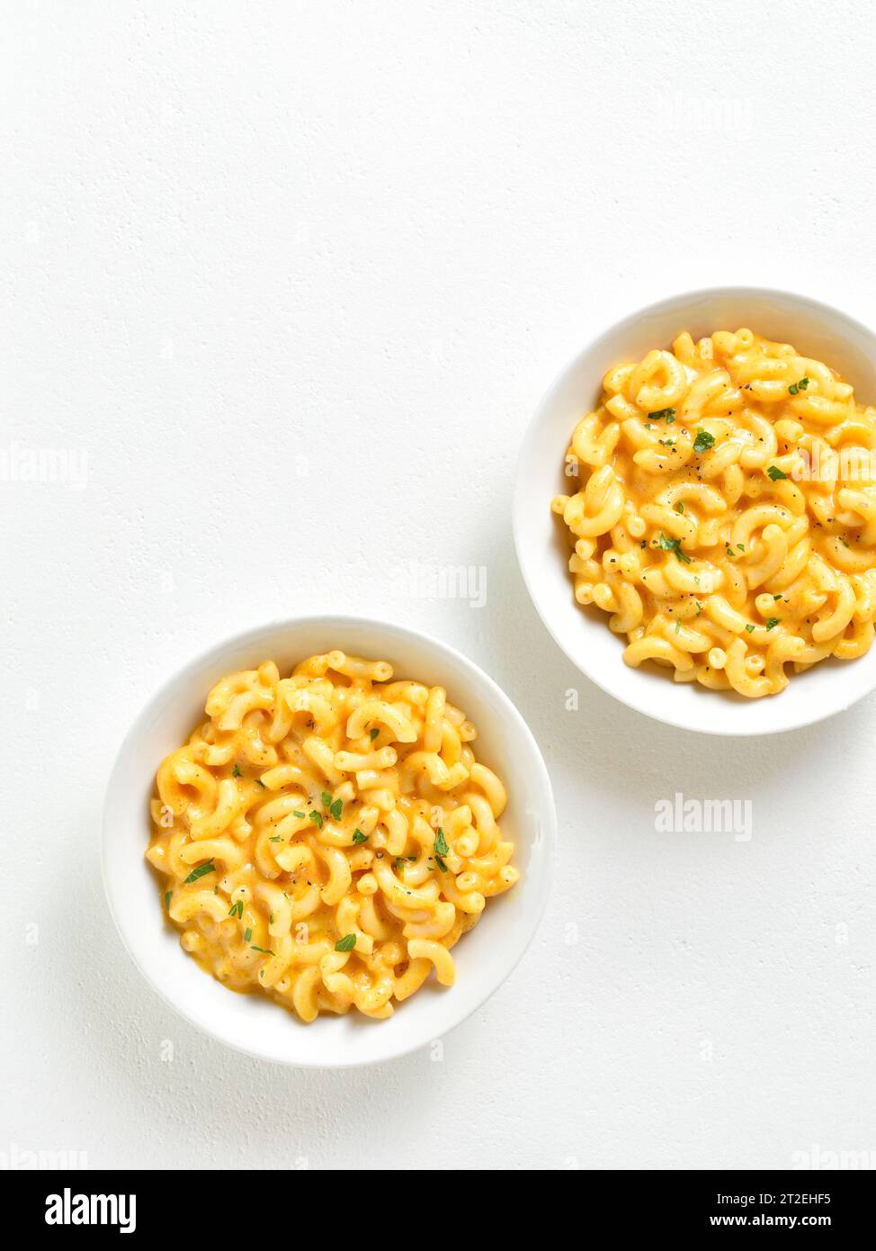 Macaroni and cheese in bowl over stone white background with free space ...