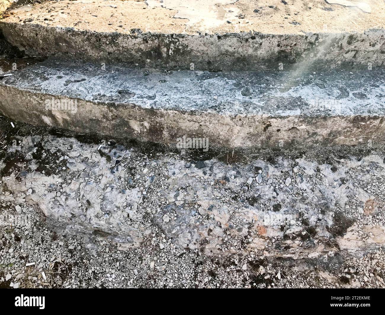 Texture of old gray concrete crumbling broken stone steps. The ...