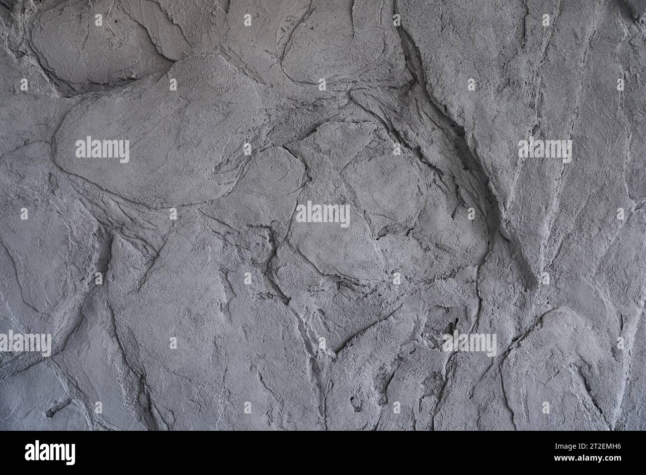 The gray texture of the stone. The cracked layered surface of the ...