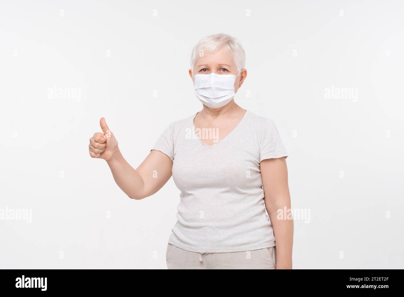 Portrait of elderly Caucasian female wearing medical face mask and ...