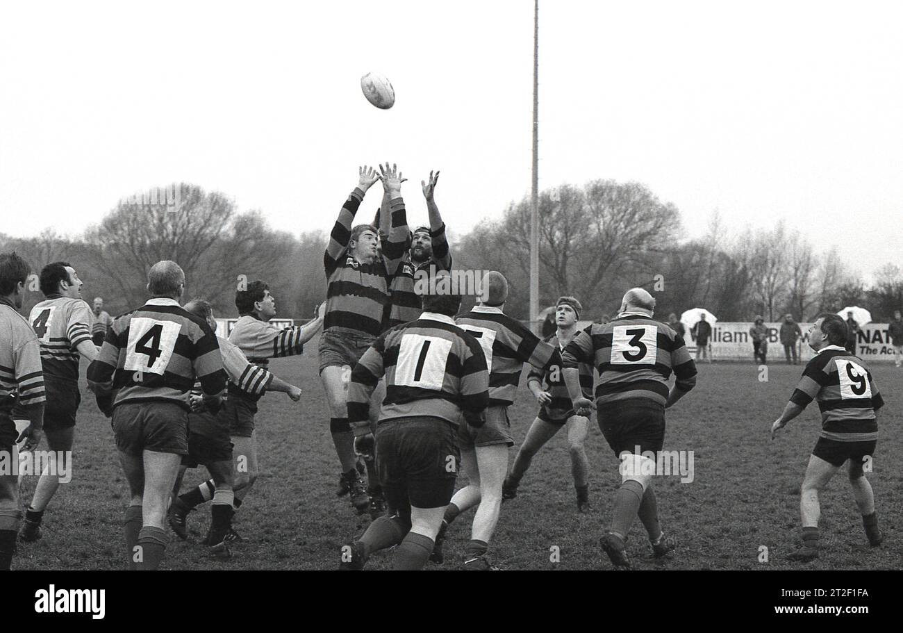 1980s, rugby match, arms stretched out, two players from the same team ...