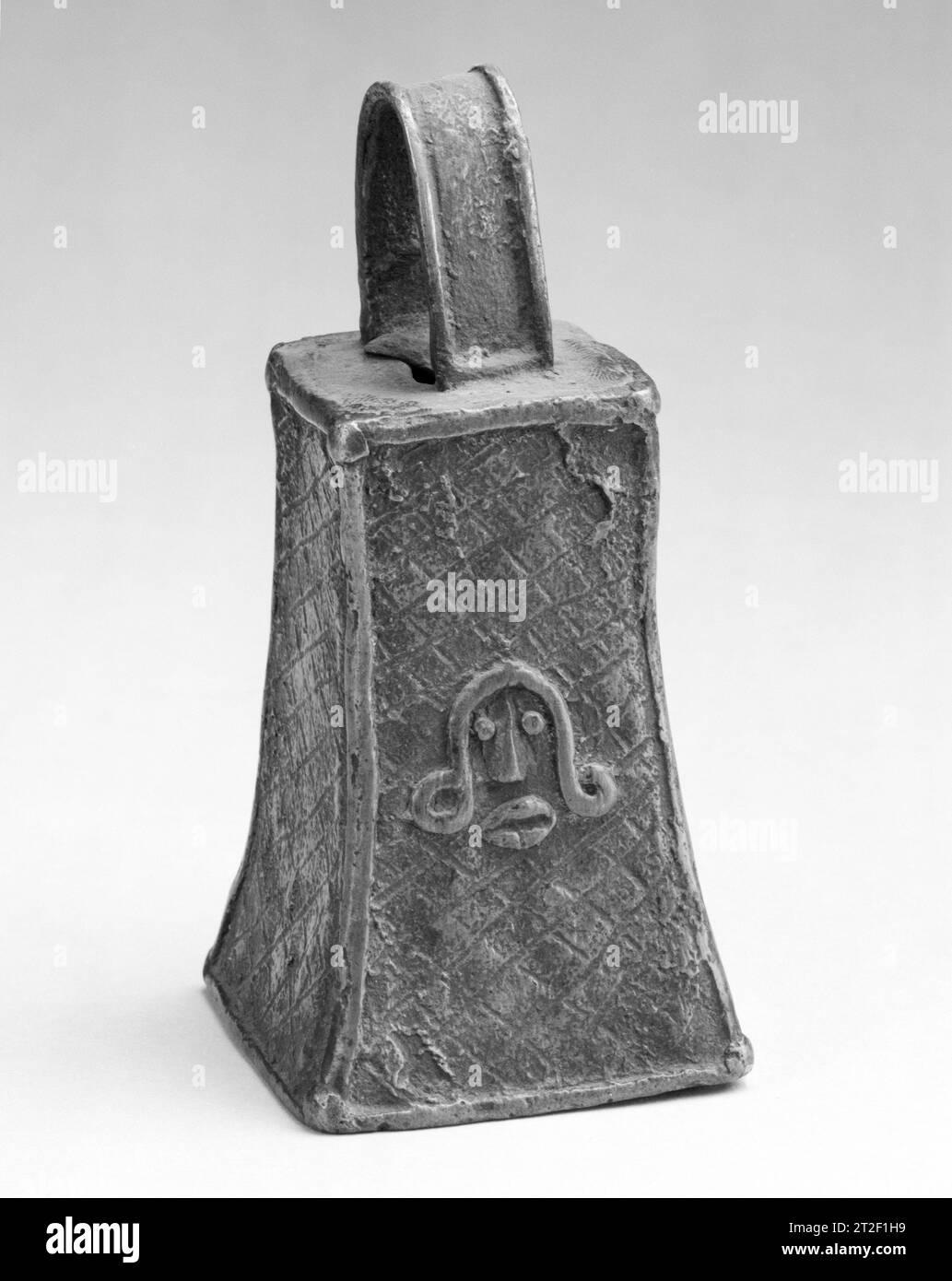 Bell Nigerian 19th century Decorated with a human face and incised ...
