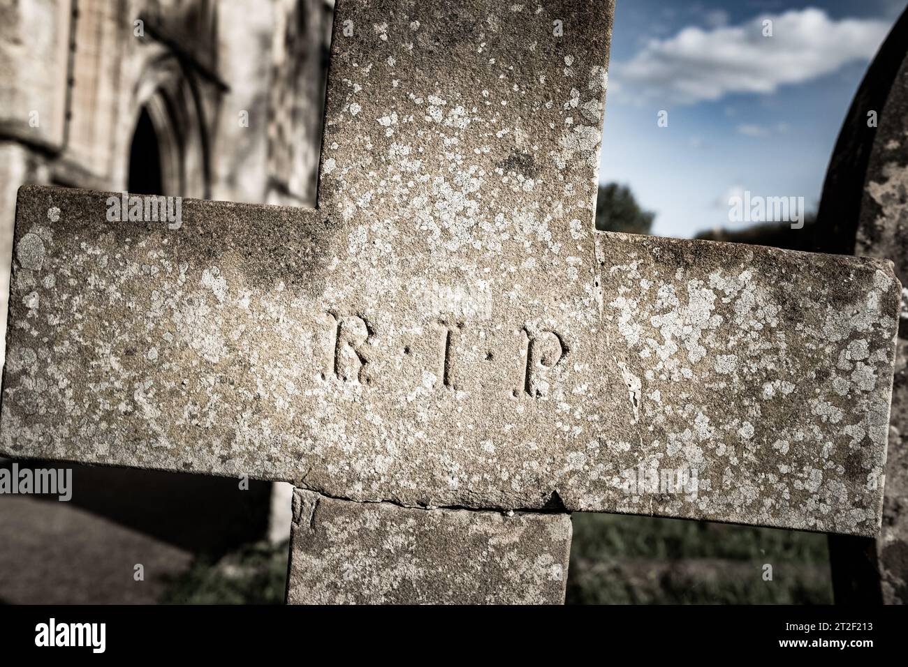 R.I.P Rest In Peace on a cross headstone in English church graveyard ...