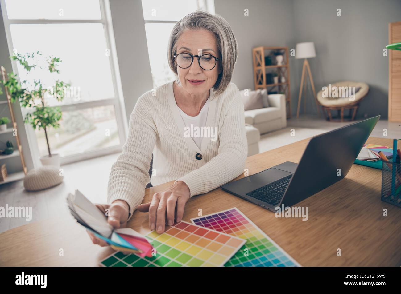 Photo of pretty shiny elderly lady wear white choosing renovation walls ...