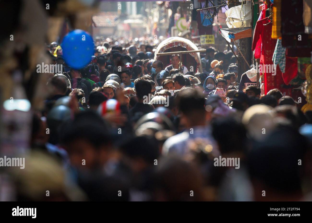 Kathmandu, Bagmati, Nepal. 19th Oct, 2023. A rickshaw passes through the crowd of people during ...
