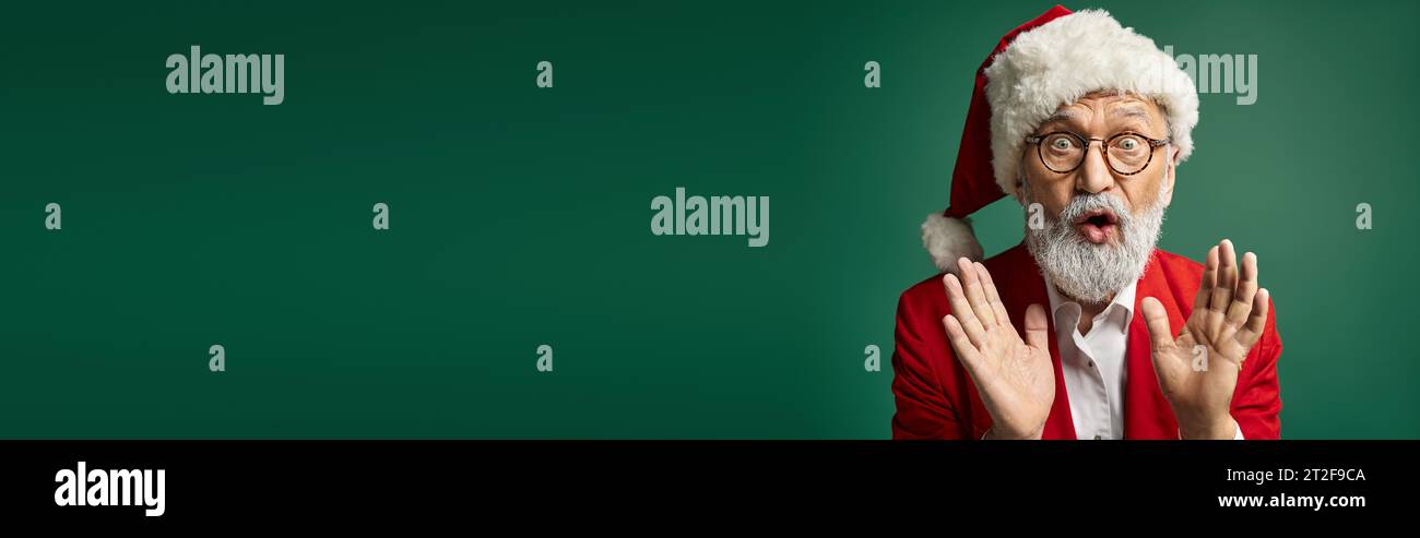shocked Santa in red elegant attire with open mouth looking at camera ...