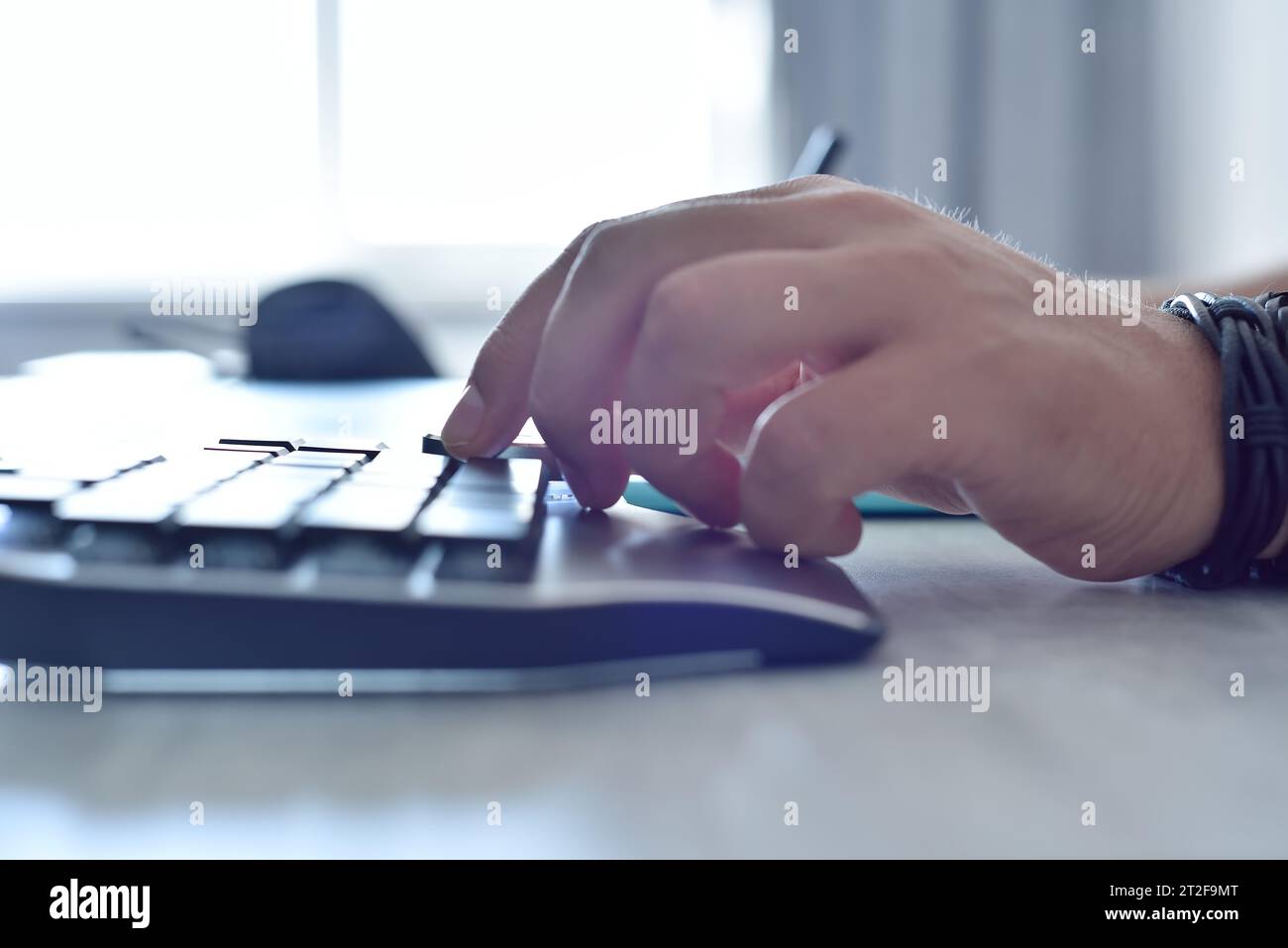 Designer working with wheel manipulator keyboard in home office. Close ...