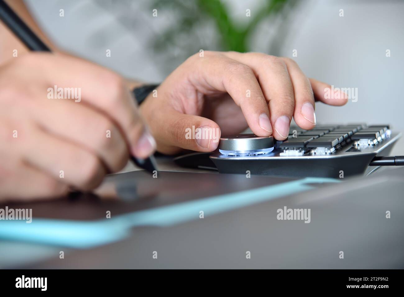 Designer using laptop computer, graphic tablet and digital control ...