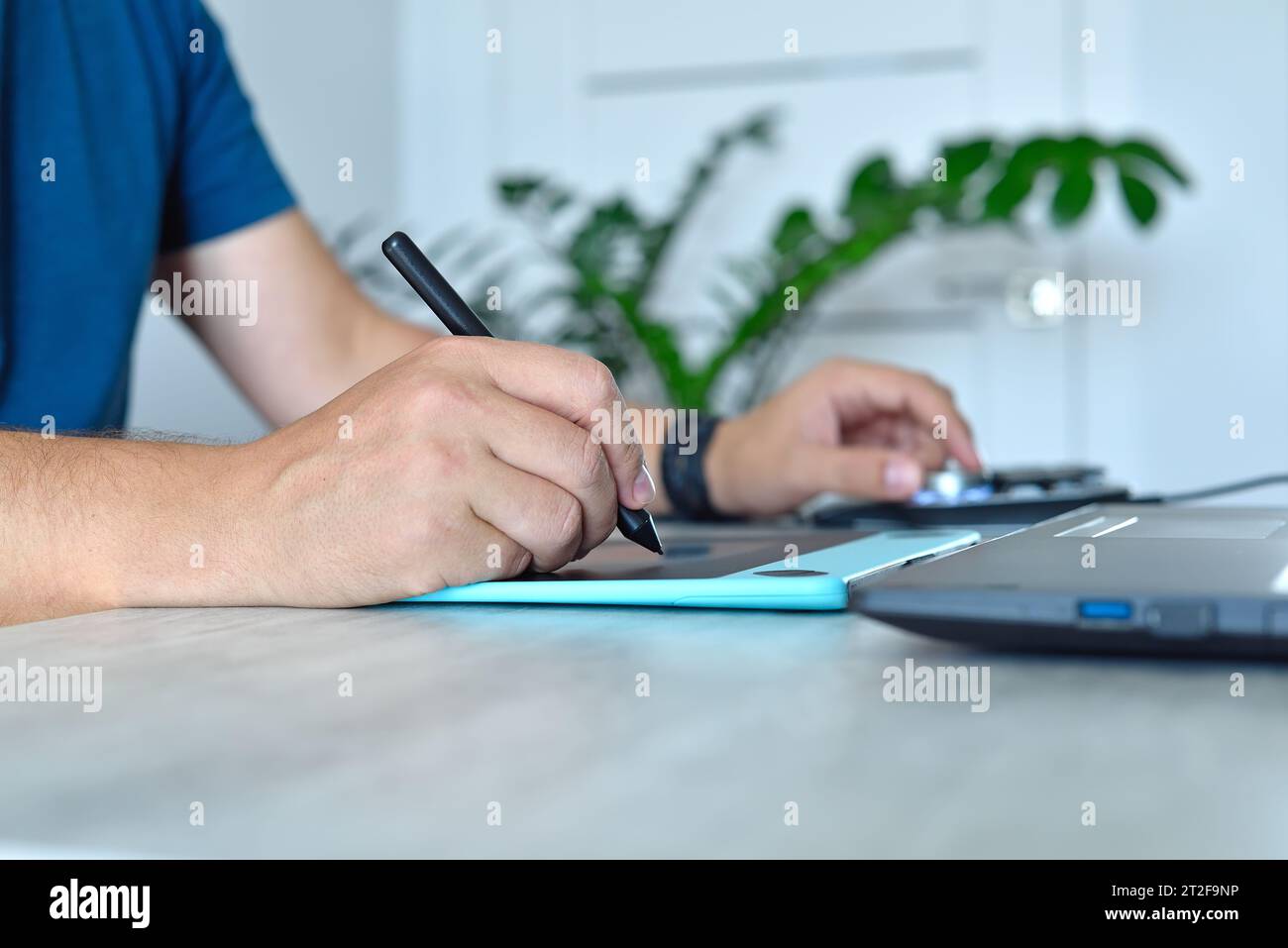 Designer working with graphic tablet and navigation control wheel ...