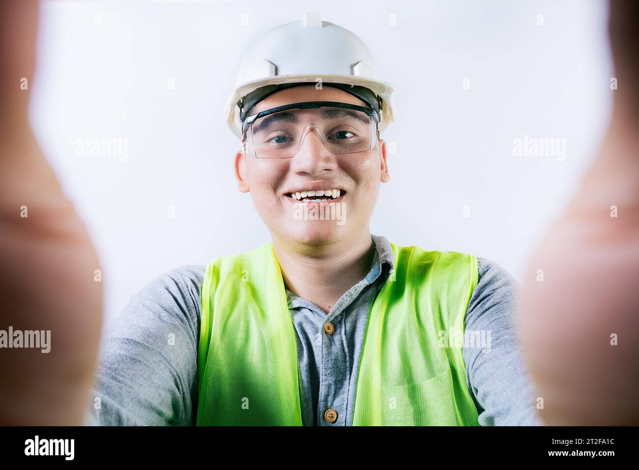 Smiling male engineer taking a selfie looking at camera. Cheerful ...