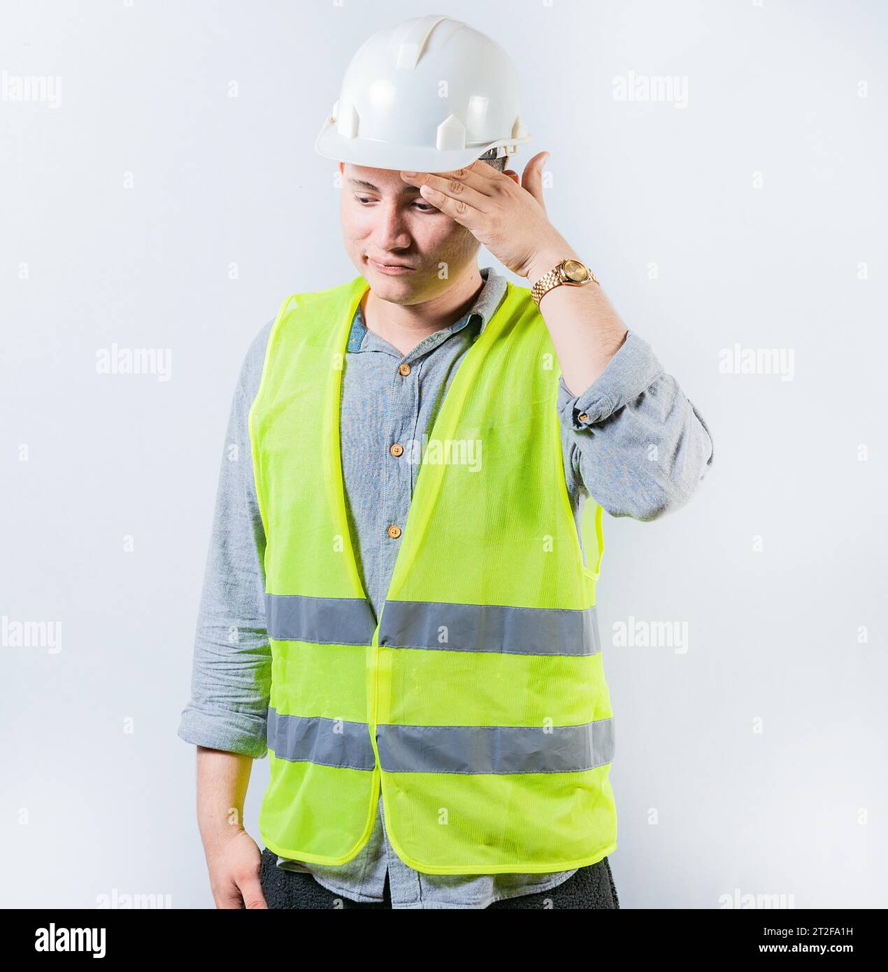 Worried young engineer holding forehead isolated. Frustrated young ...