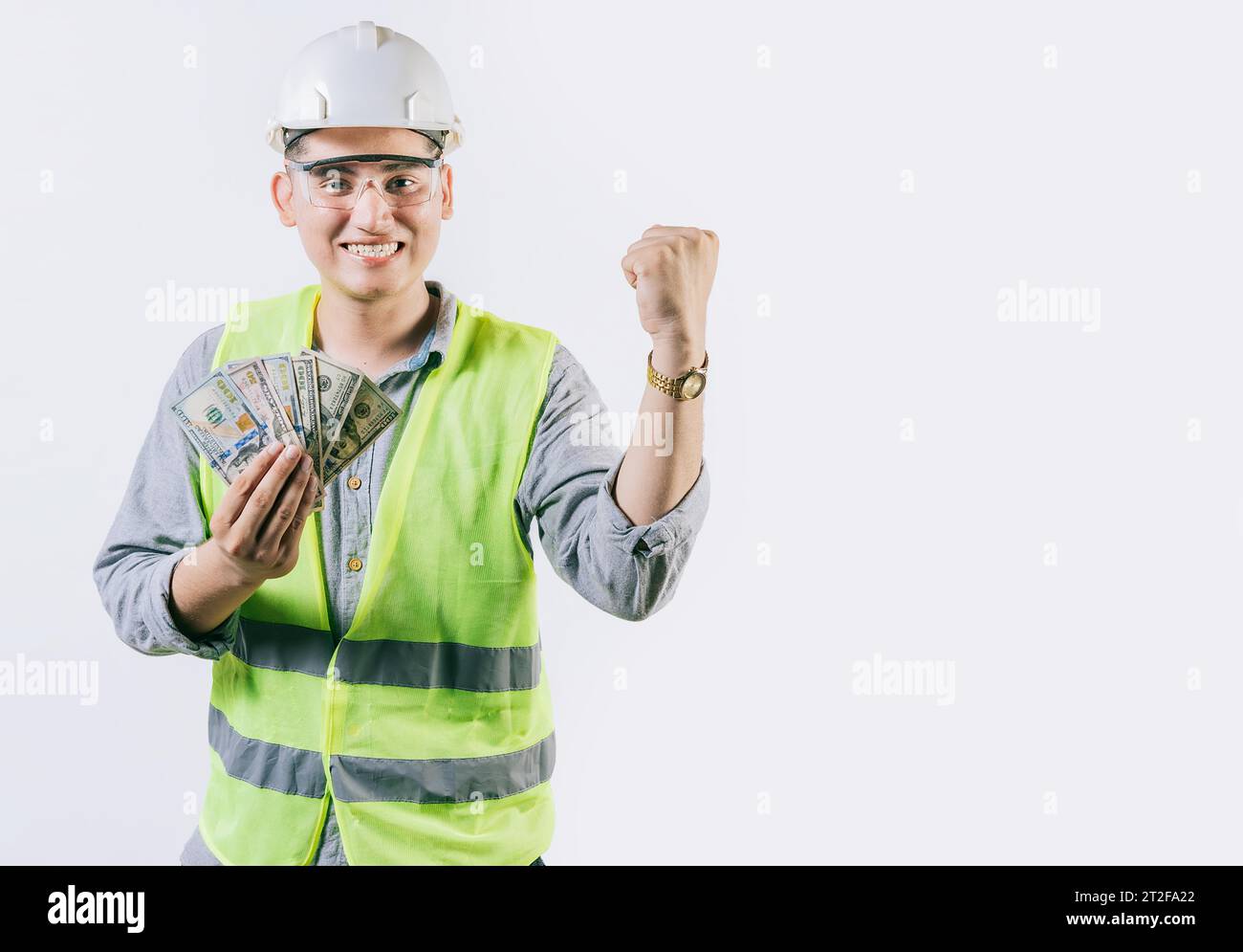 Happy engineer holding money celebrating isolated. Excited engineer ...
