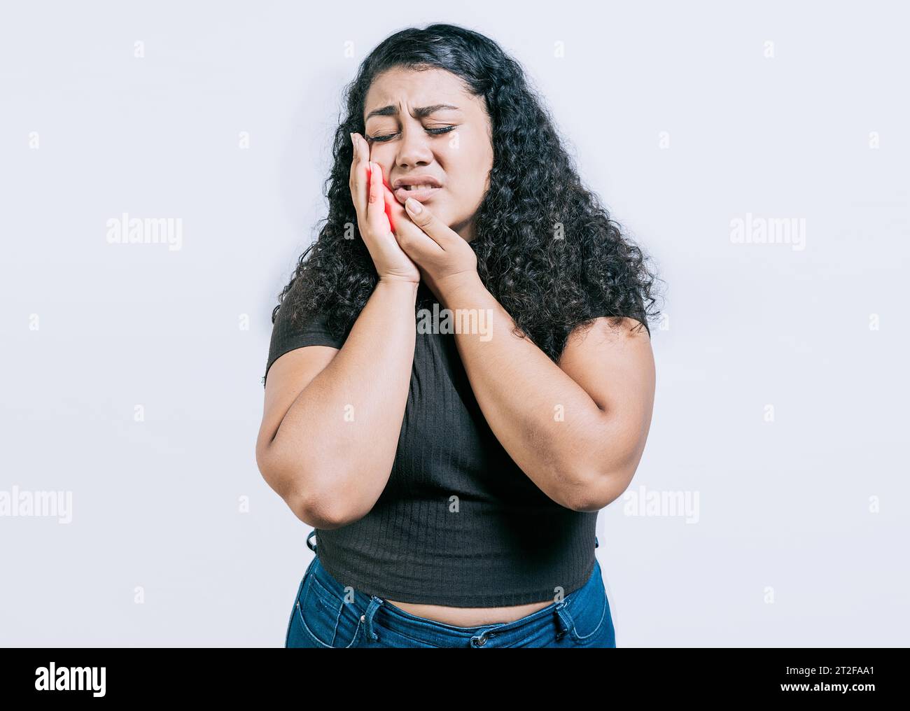 Young woman suffering with toothache isolated. Girl rubbing cheek with ...