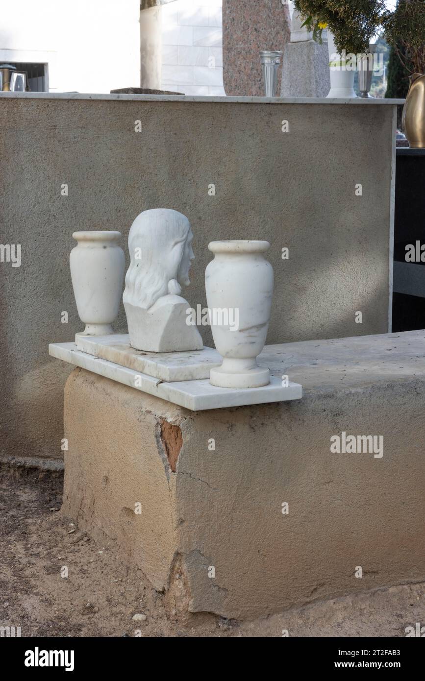 Simple grave with crumbling plaster, white god figure and empty white ...