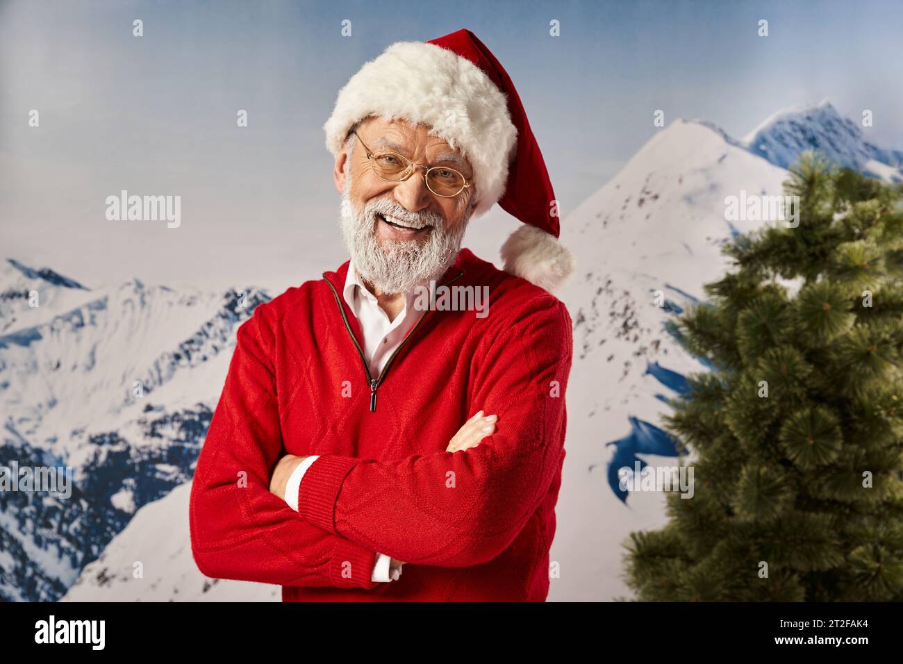 joyous Santa in christmassy hat with glasses with his arms crossed on ...