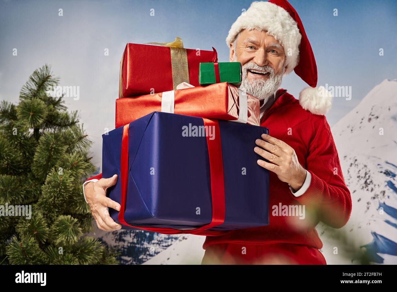 happy Santa holding huge pile of presents and smiling cheerfully at ...