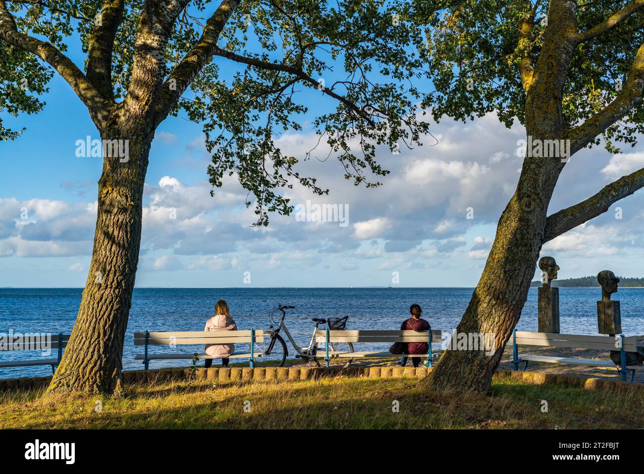 People sitting on the bench at the Utkiek lookout point with a view ...