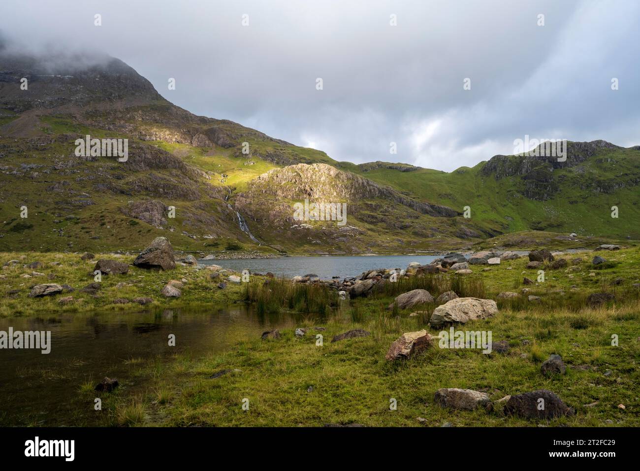 Lake Llyn Llydaw with Mount Snowdon behind clouds in late summer ...