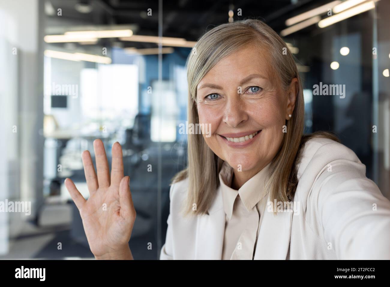 Close-up photo of senior smiling business woman talking on video camera ...