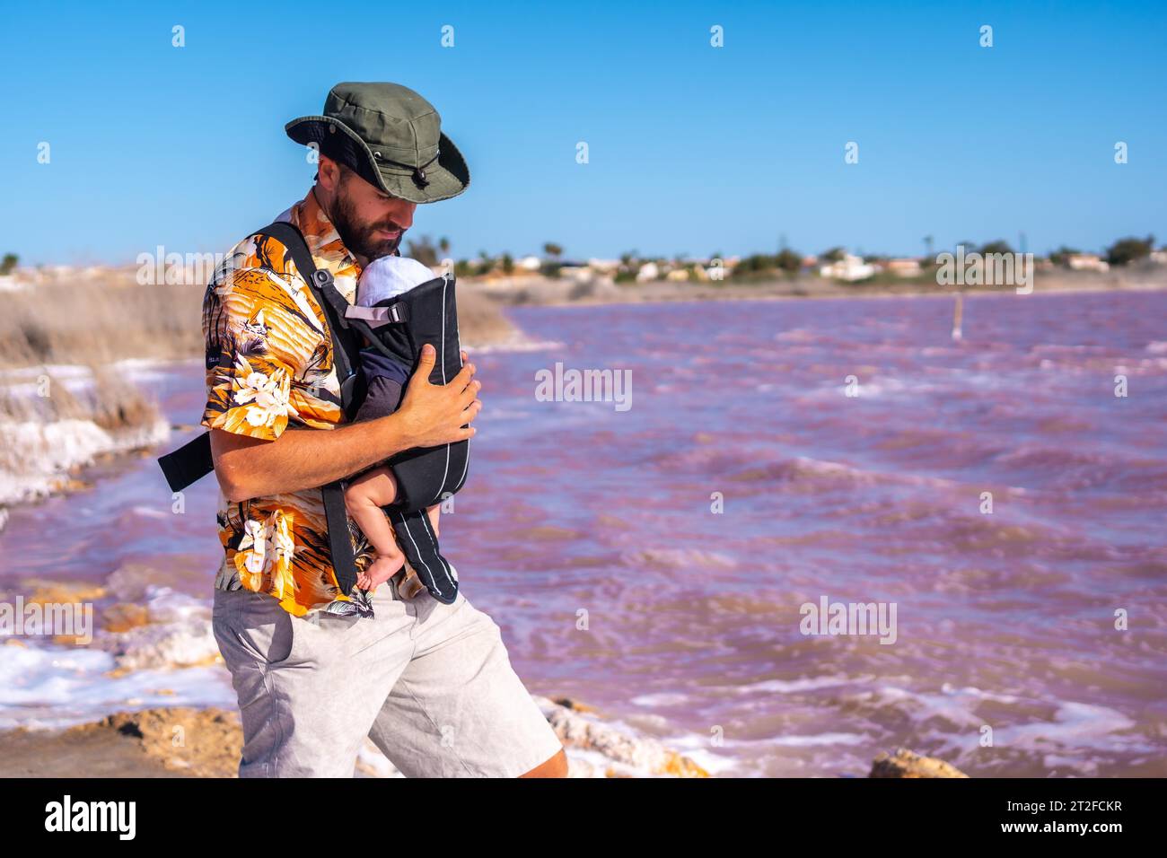 Young father visiting the pink lagoon of Torrevieja, Alicante ...