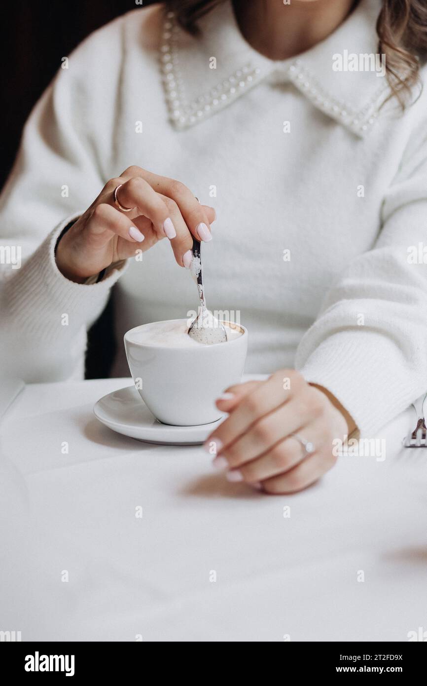 Woman stirs cup coffee coffee hi-res stock photography and images - Alamy