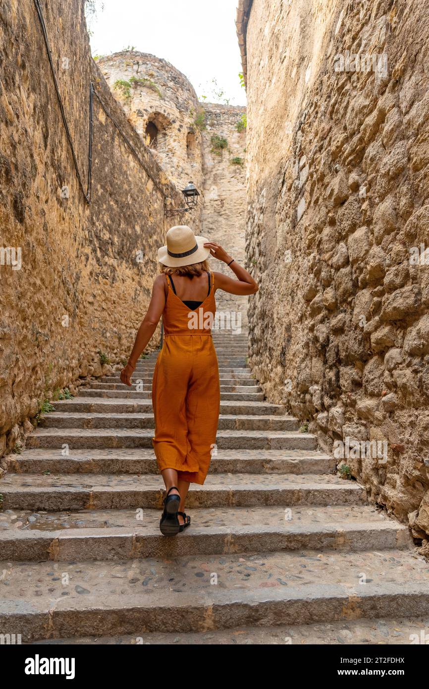 Girona medieval city, a young tourist with a hat on the stairs of the ...