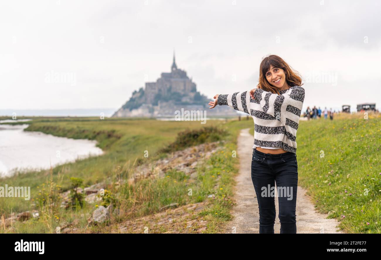 A young tourist walking from Point de Vue towards the Abbey of Mont ...