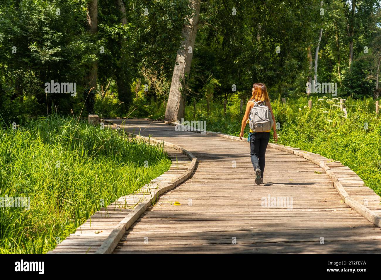 A young woman on the footpath along a footbridge between La Garette and ...