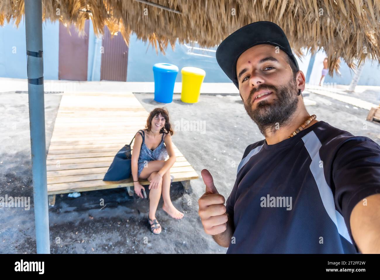 A tourist couple enjoying the beach of Puerto Naos on the island of La Palma in summer. Canary ...