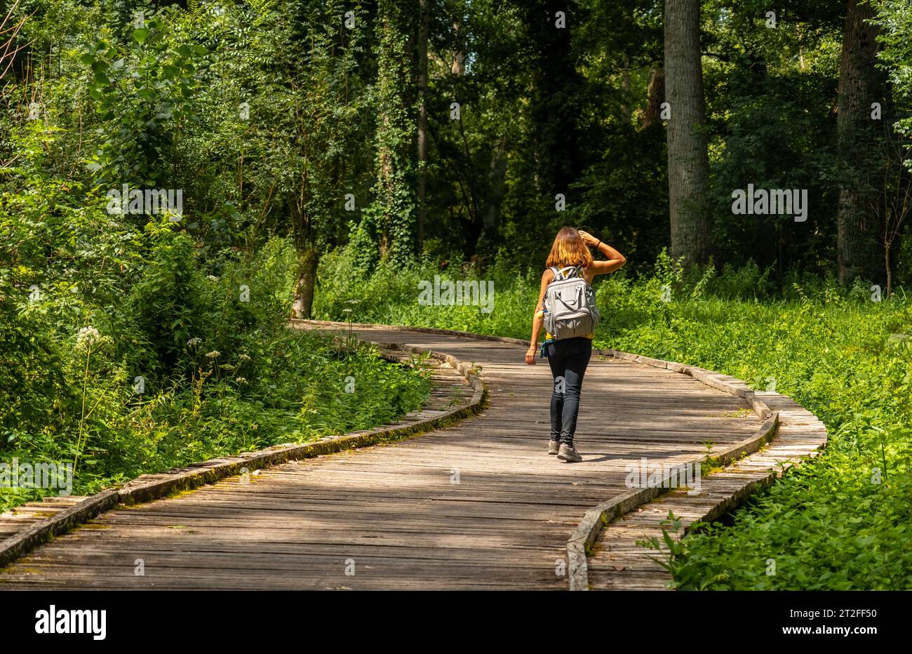 A young woman walking on the trek on the trail between La Garette and ...