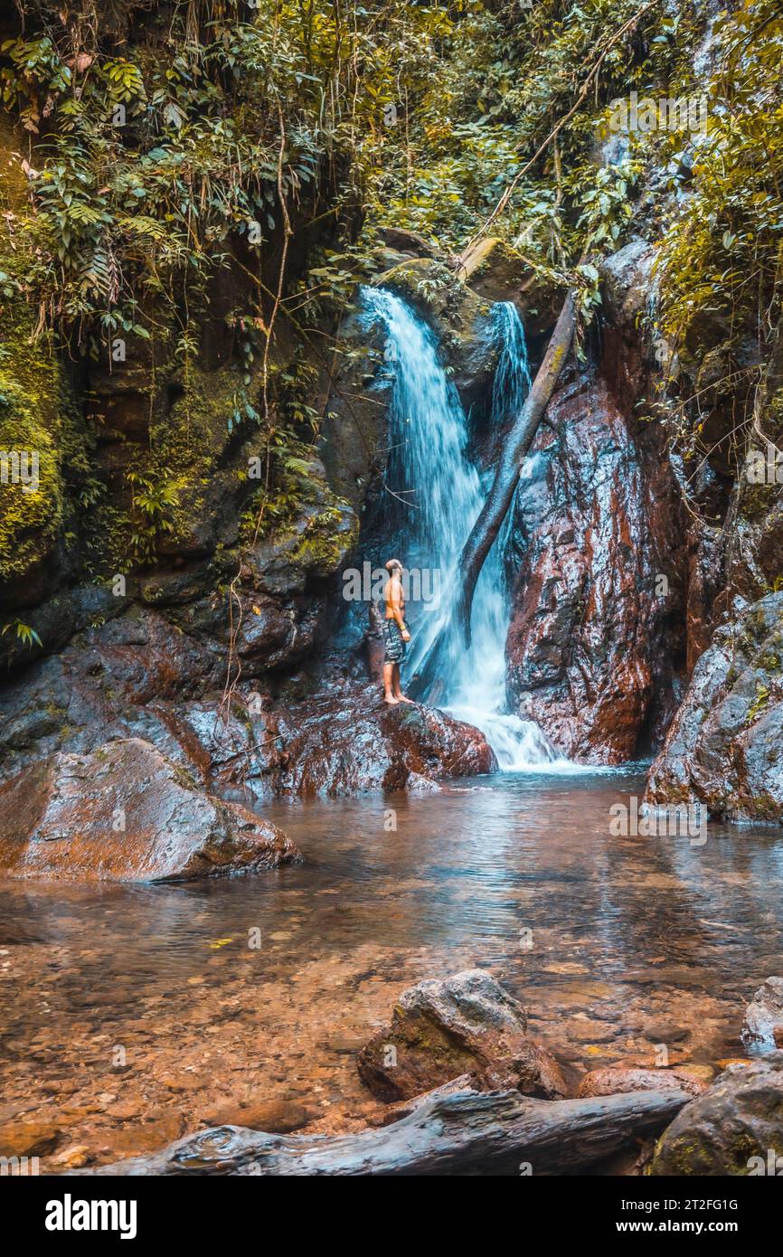 A young man in a waterfall of the Cerro Azul Meambar National Park ...