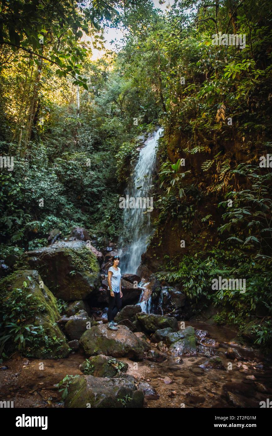 A cheerful young woman in the Cascada del Cerro Azul Meambar National ...