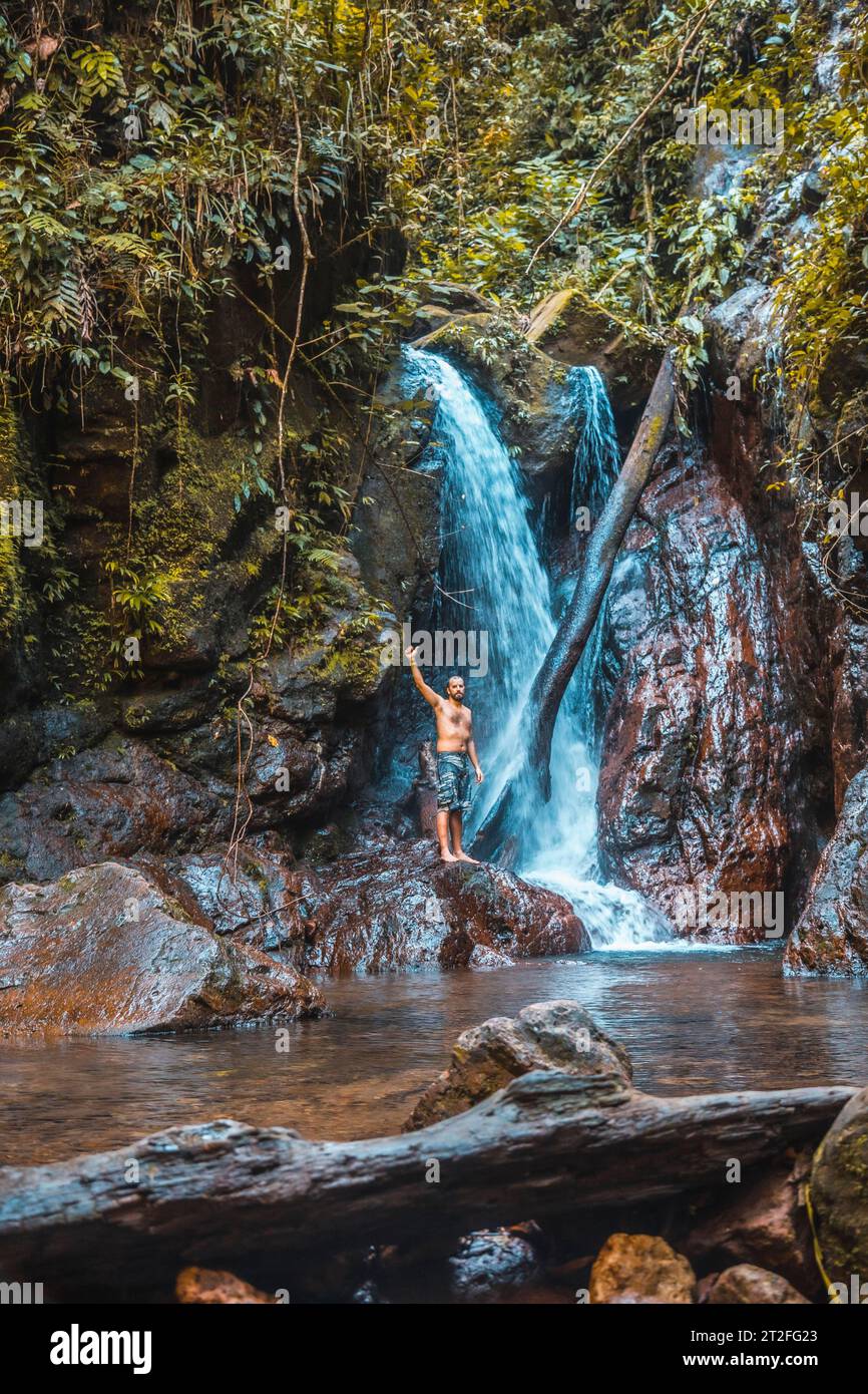 A young man in a waterfall of the Cerro Azul Meambar National Park ...