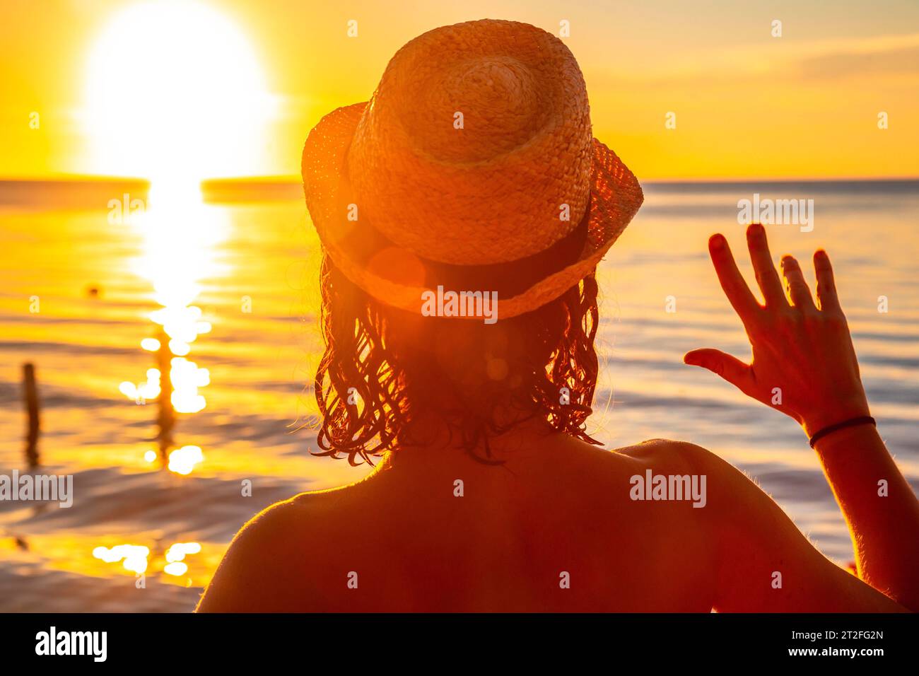 A young girl with a hat on a sunset in Roatan. Honduras Stock Photo - Alamy