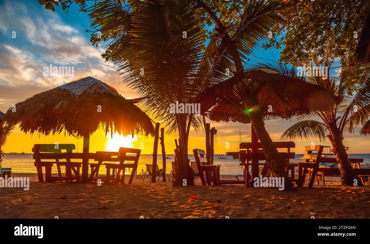 A terrace on the beach at Sunset from West End Beach, Roatan Island ...