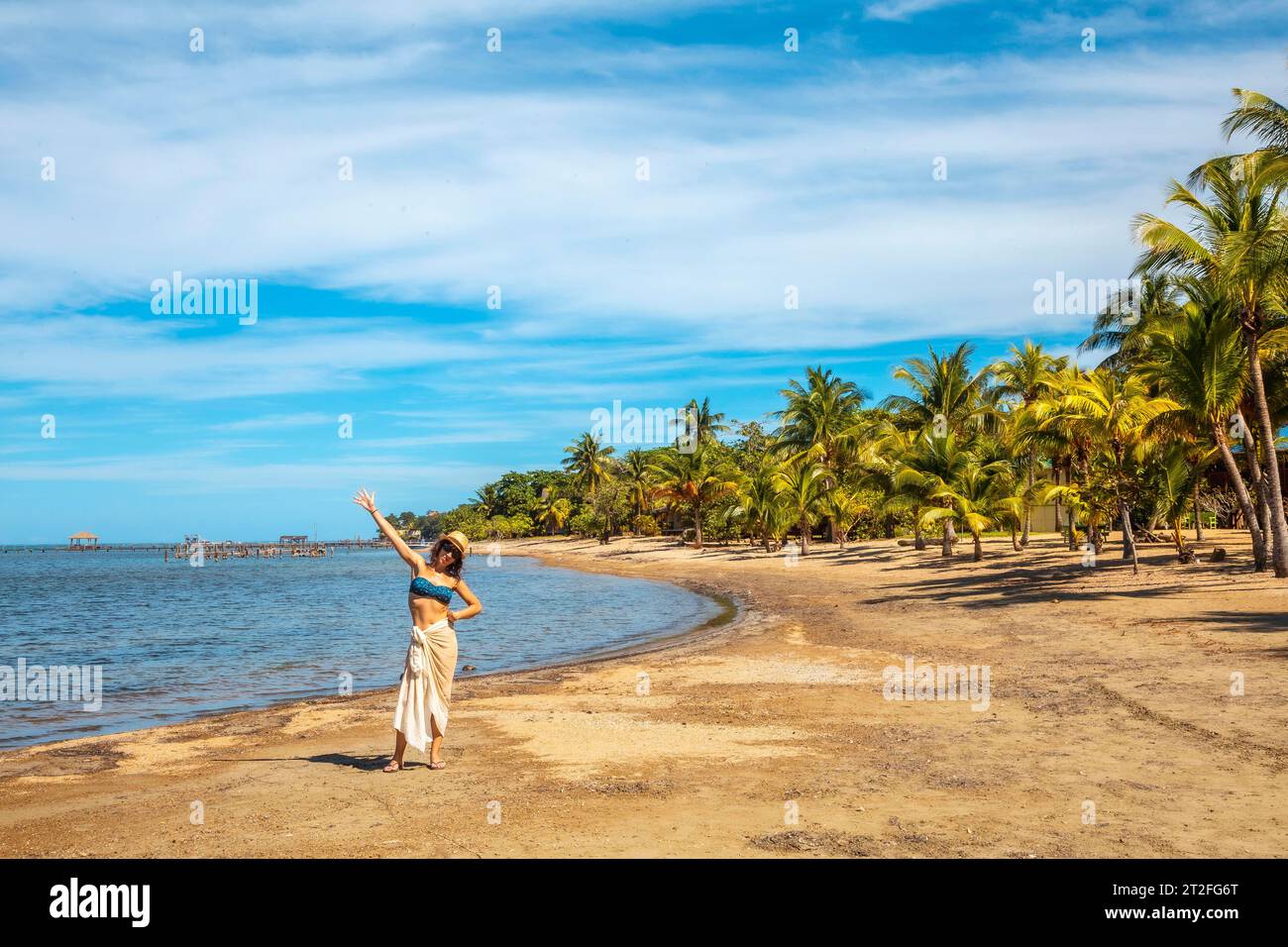 A young tourist on the beach of Sandy Bay on Roatan Island. Honduras ...