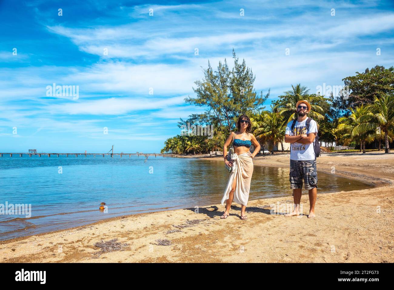 Two young men on the beach of Sandy Bay on Roatan Island. Honduras ...