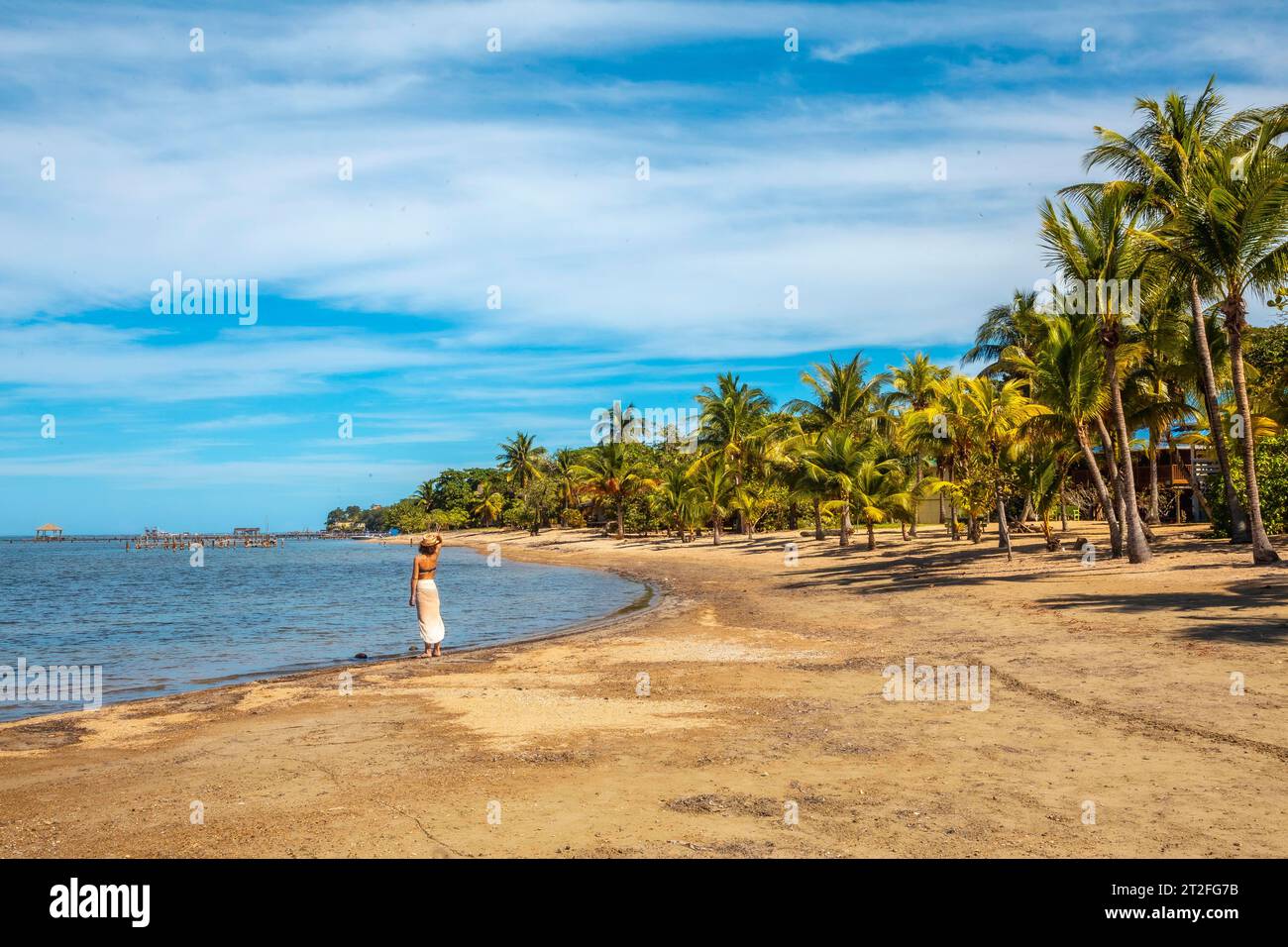 A young tourist on the beach of Sandy Bay on Roatan Island. Honduras ...