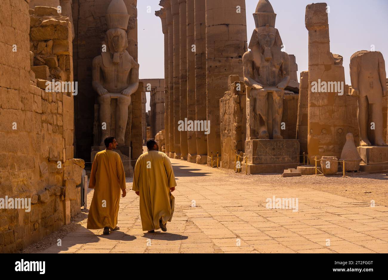 Two local men visiting the Egyptian Temple of Luxor and its precious ...