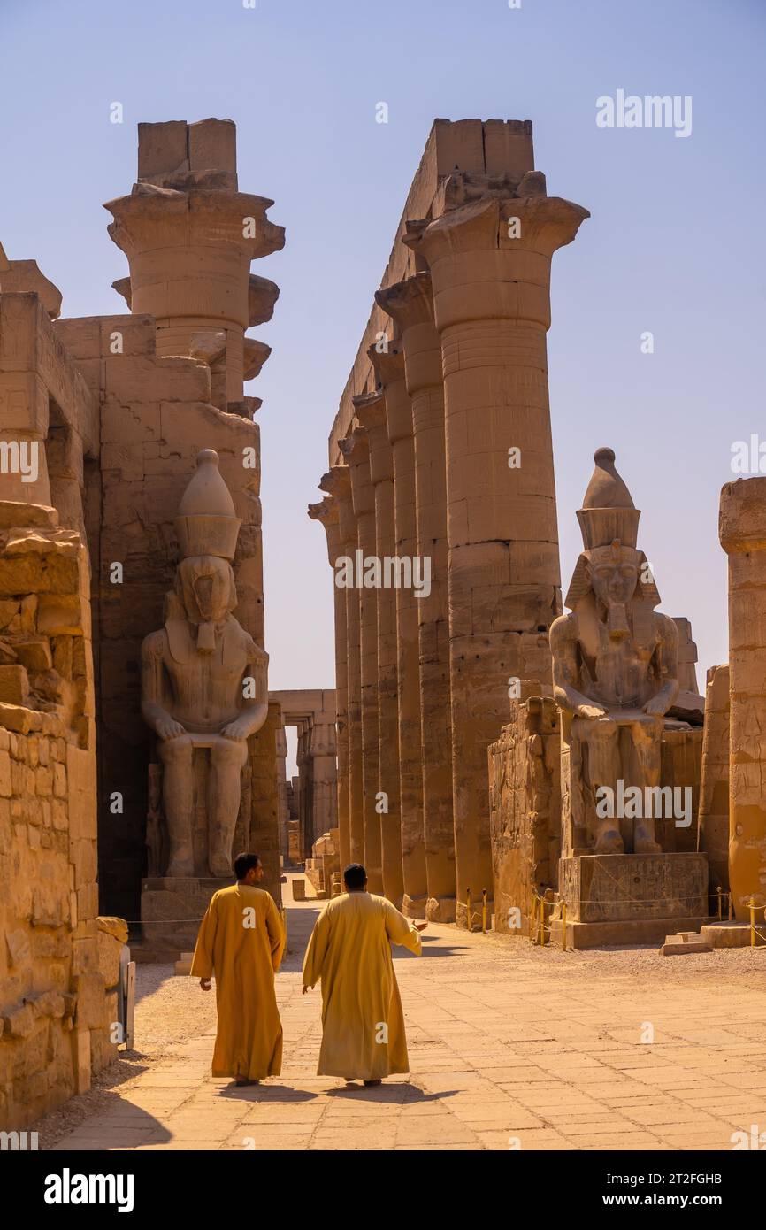 Two local men visiting the Egyptian Temple of Luxor and its precious ...