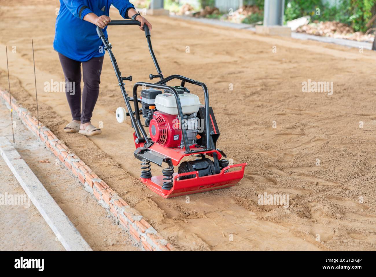 Worker use vibratory plate machine compactor for construction ...