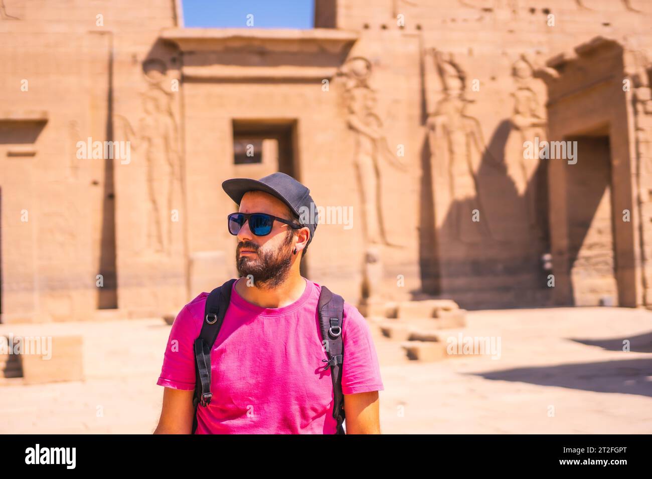 A young man in a pink shirt at the Temple of Philae, a Greco-Roman ...